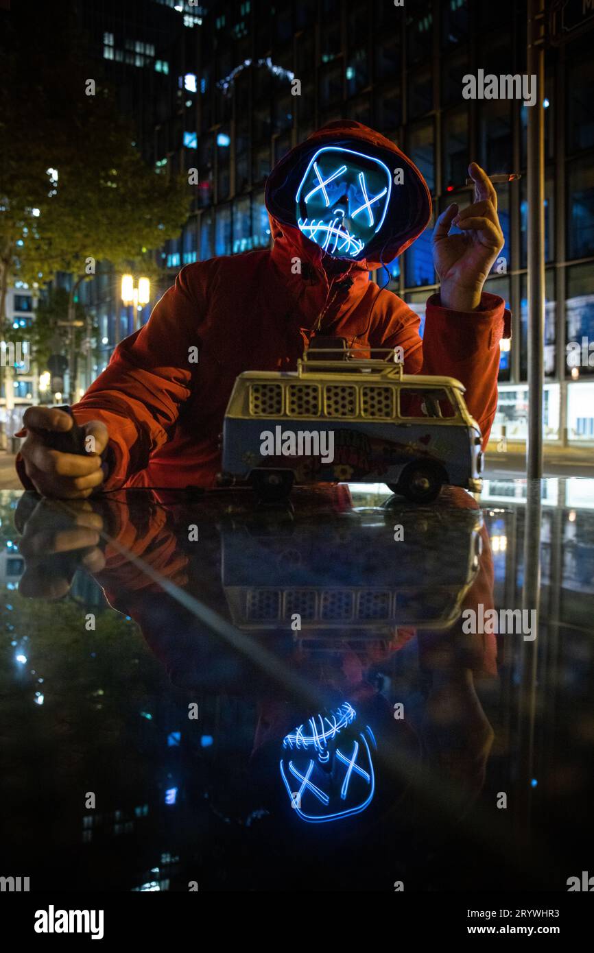 Night of the Purge: Person with LED Mask and Halloween Pumpkin in ...