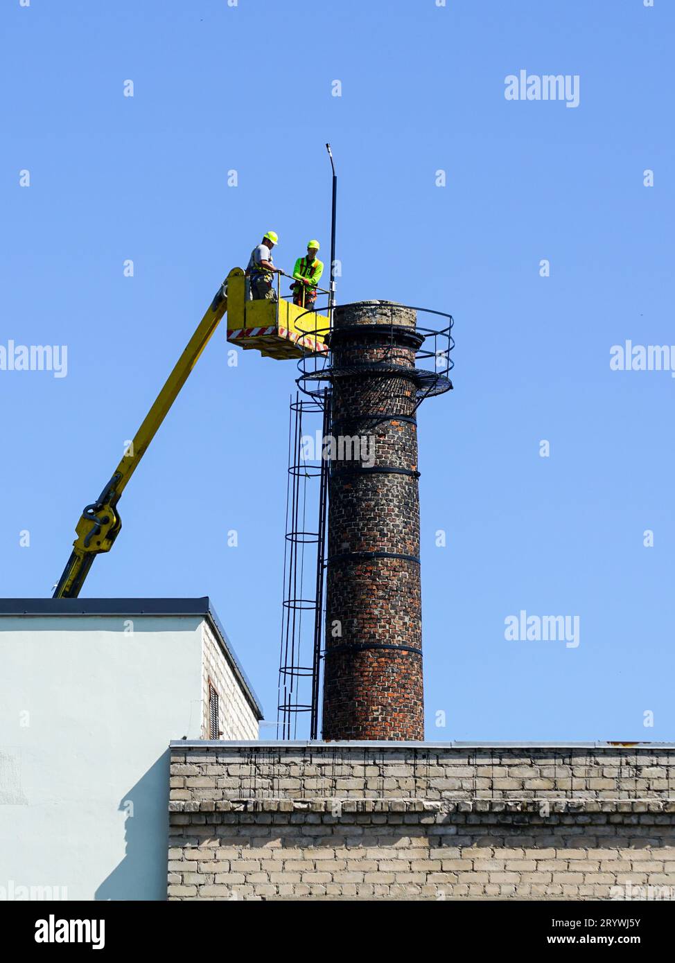 Inspection of the technical condition of an old tall red brick ...