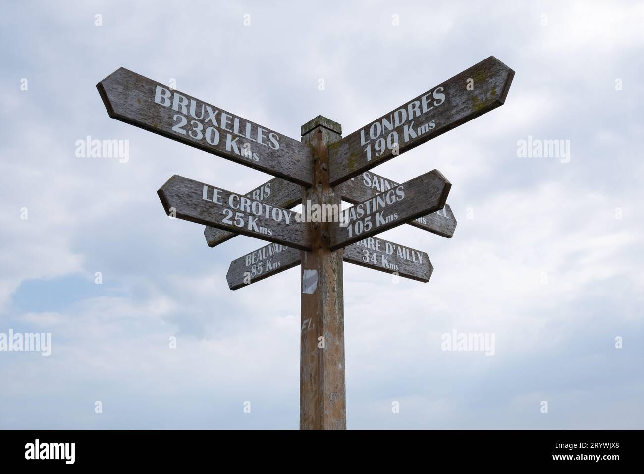 A wooden post with various signs attached a speed limit sign and a ... A wooden post with various signs attached a speed limit sign and a ...