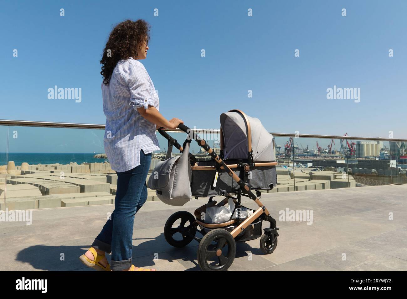 Full length portrait of a multi-ethnic, curly haired young woman ...