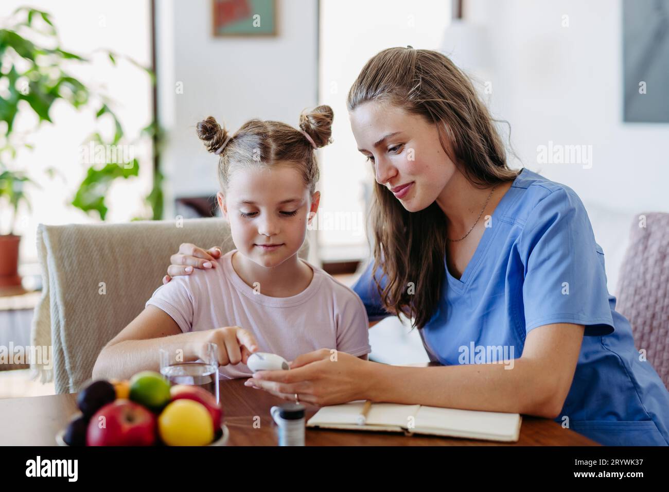 Nurse checking girl's blood glucose level using a fingerstick glucose ...
