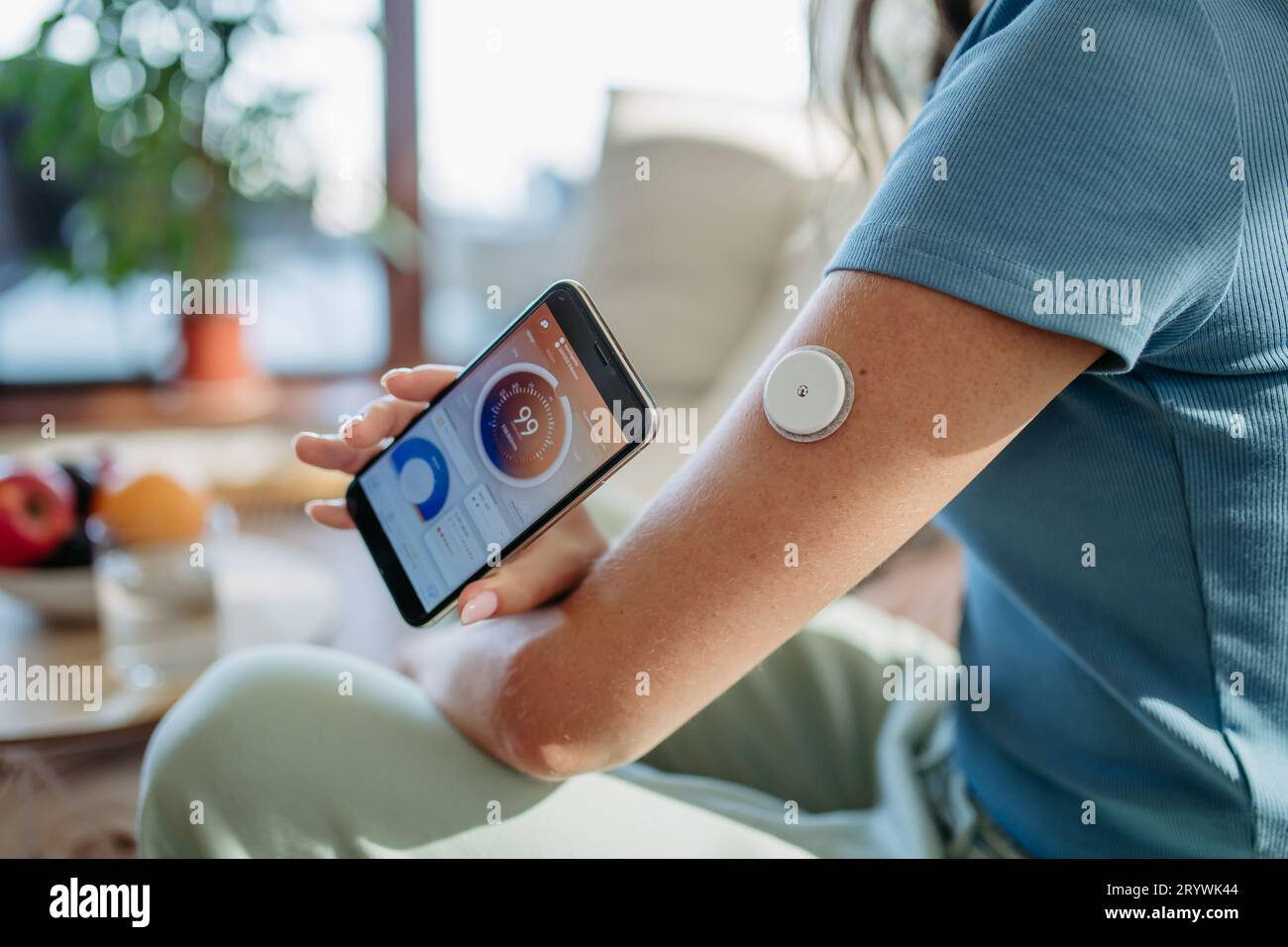 Woman with diabetes checking blood glucose level at home using ...
