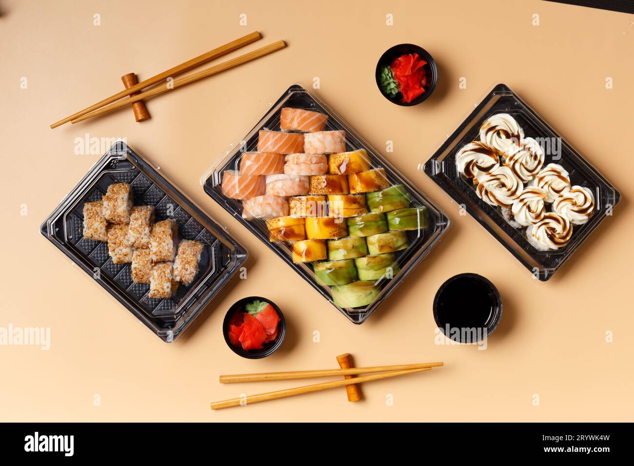 A set of sushi rolls in takeaway plastic packages with soy sauce ...