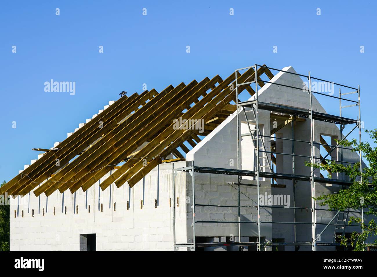 Unfinished residential house with white block walls and a wooden beam ...