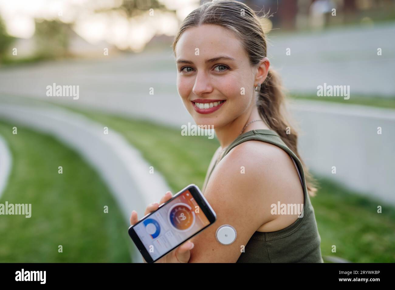 Woman with diabetes checking blood glucose level outdoors using ...