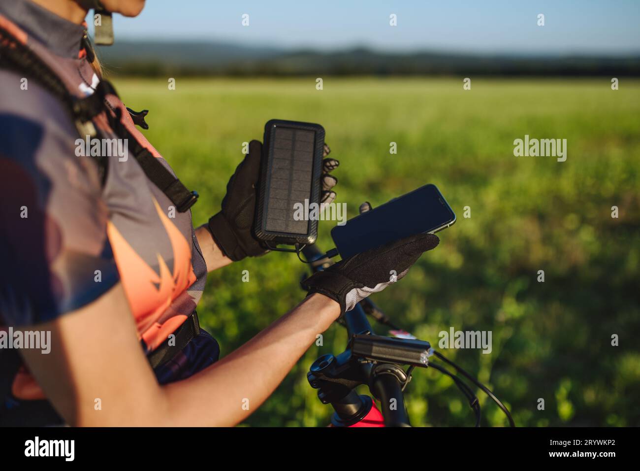 Cyclist charging her smartphone using a solar phone charger Stock Photo ...