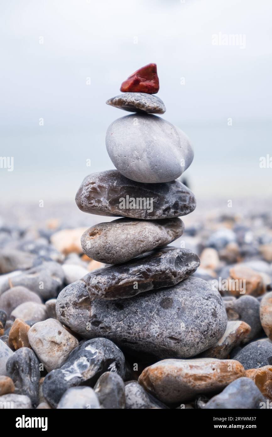 A pile of jagged rocks with a bright red hat perched atop them ...
