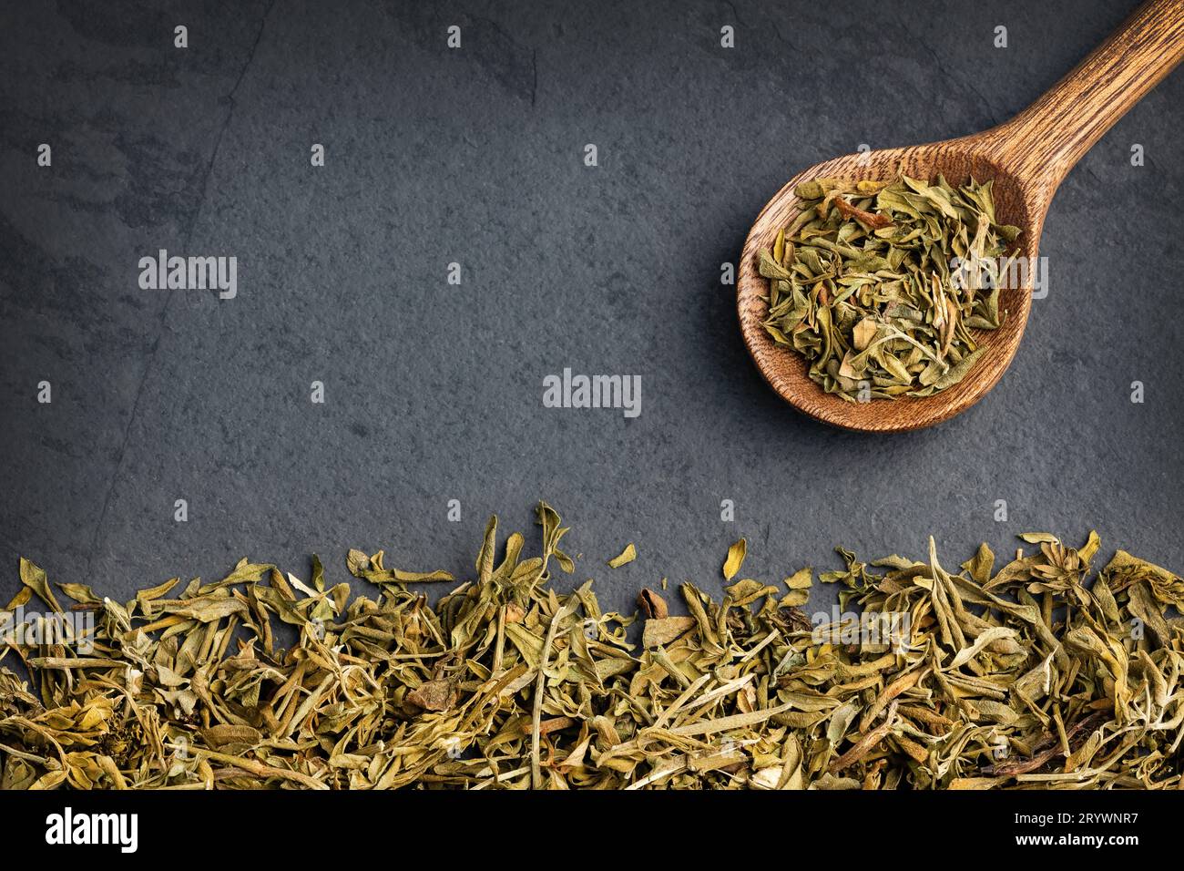 Dried rue leaves in the spoon - Ruta graveolens Stock Photo - Alamy