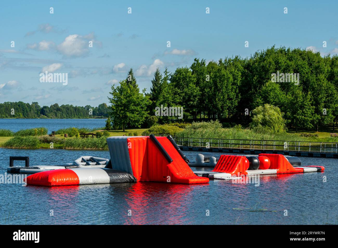 View of inflatable floating water park in the lake Stock Photo - Alamy