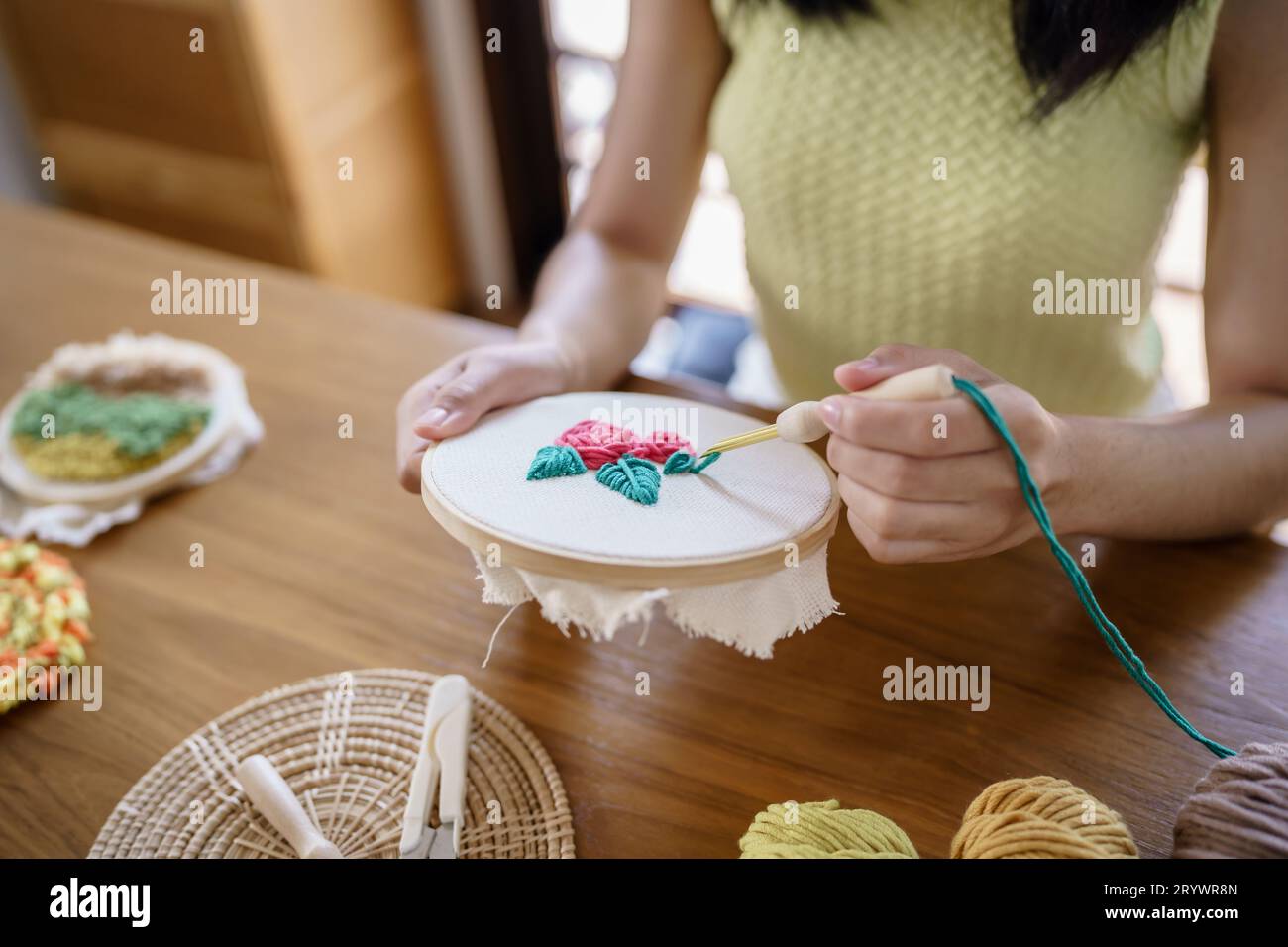 Punch needle. Asian Woman making handmade Hobby knitting in studio ...