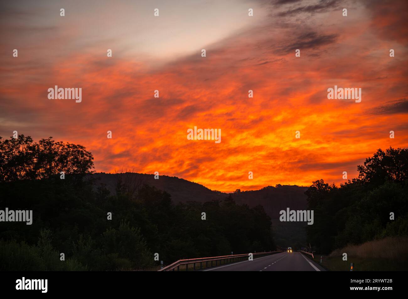 Summer orange - red sunrise above road very early in morning. Photo was ...