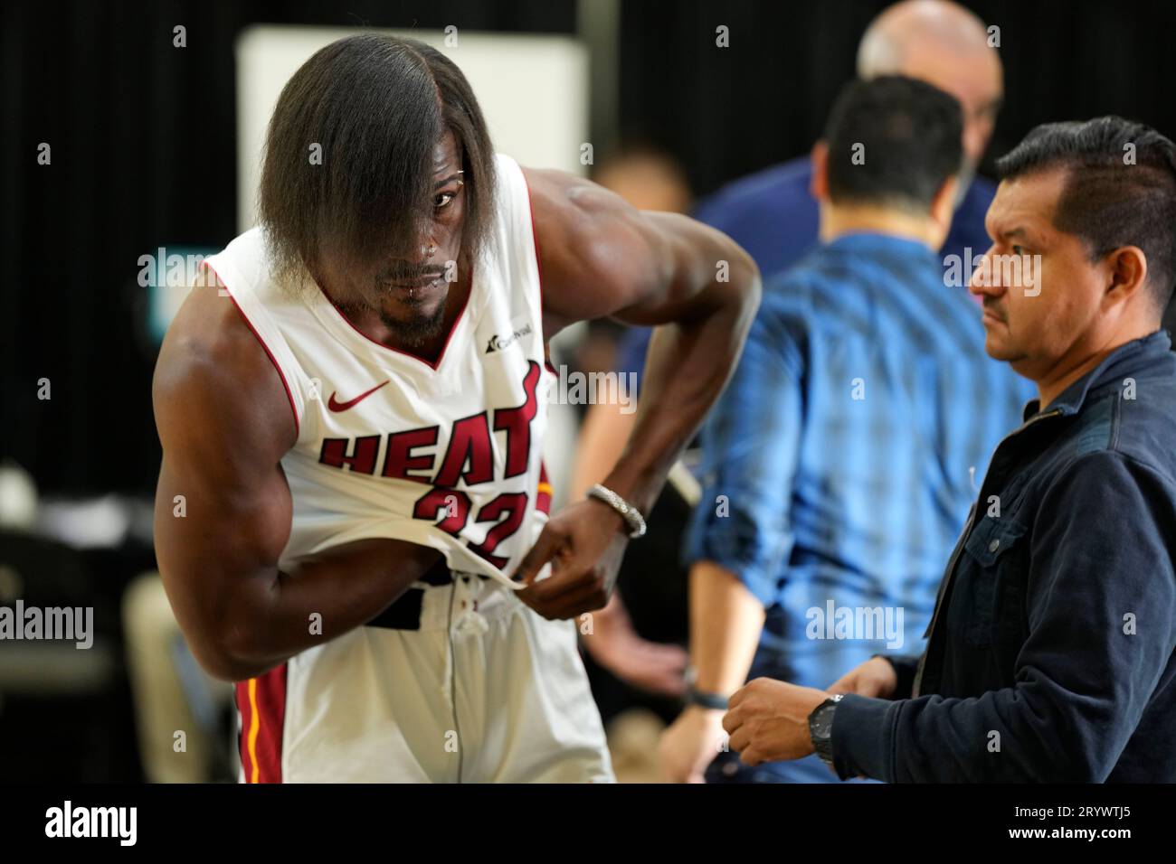 Miami Heat forward Jimmy Butler removes a mic as he rotates between ...