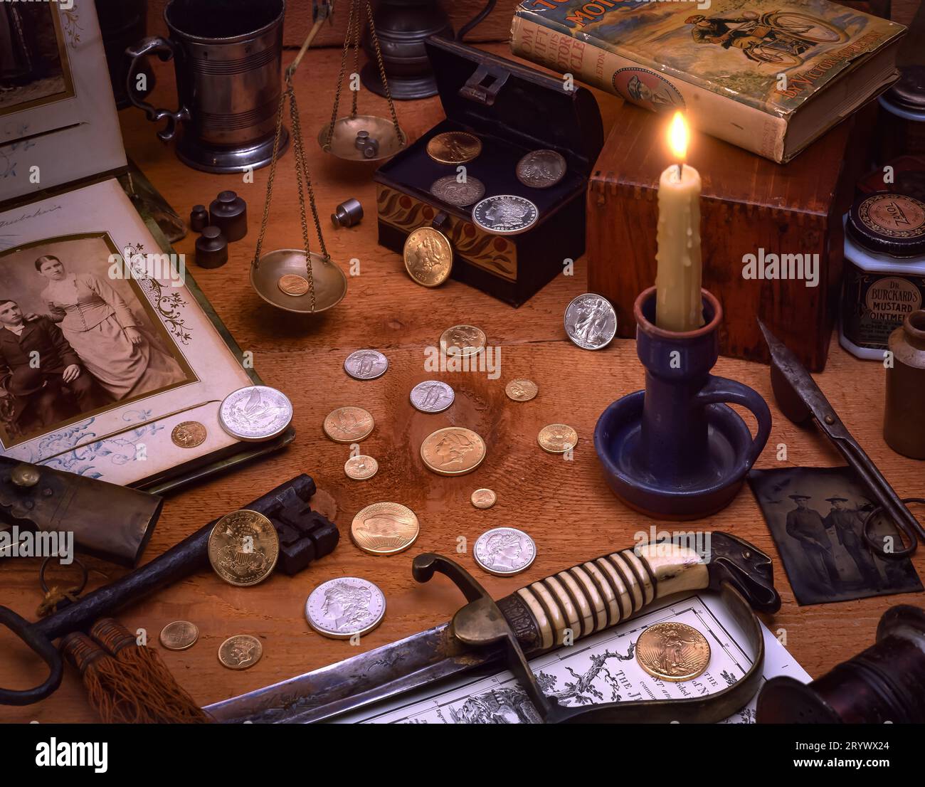 Still life studio set up antique coins, currency, sword, key, candle ...