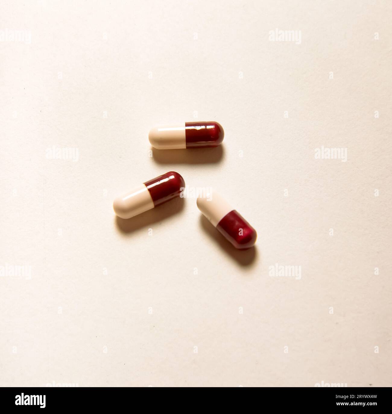 Three red and white capsules on white background, copy space Stock ...