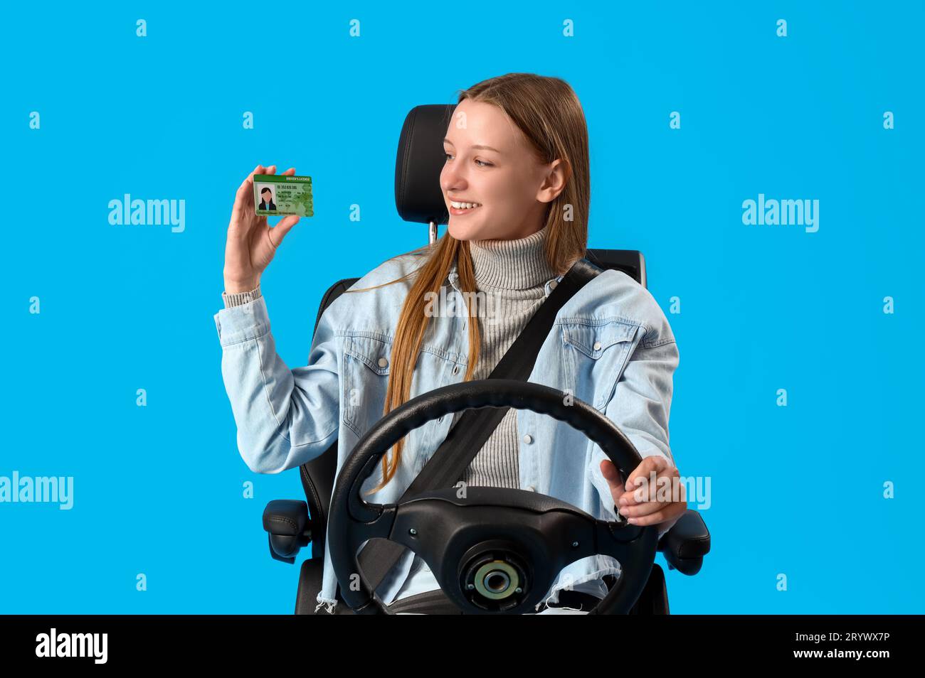 Female student with driving licence and steering wheel in car seat on ...