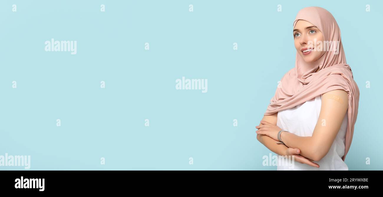Muslim woman with medical patch on arm against blue background with ...