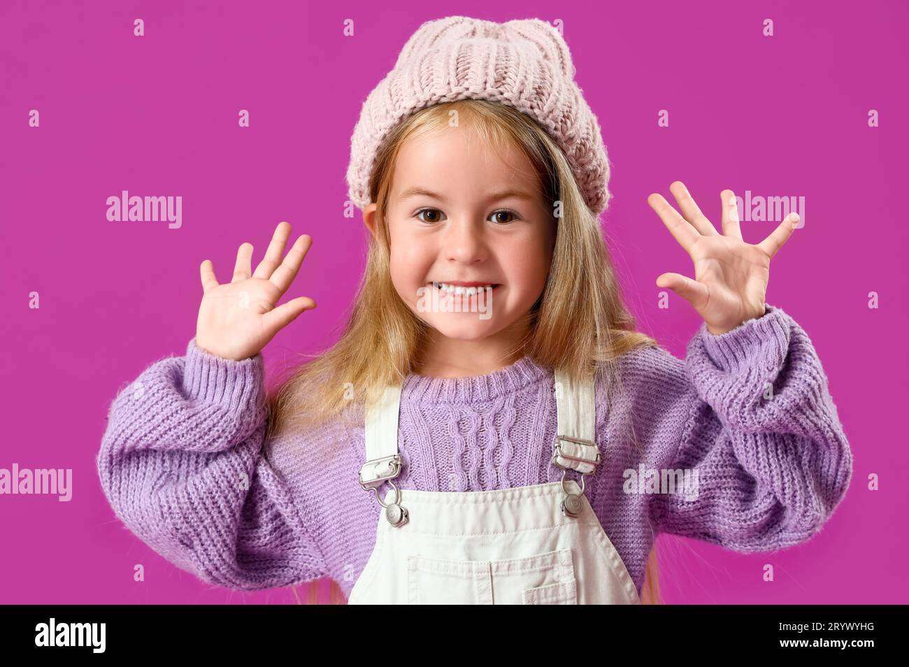 Cute little girl on purple background Stock Photo - Alamy