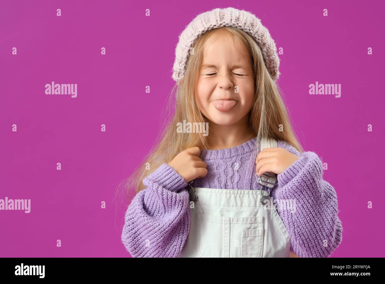Cute little girl on purple background Stock Photo - Alamy
