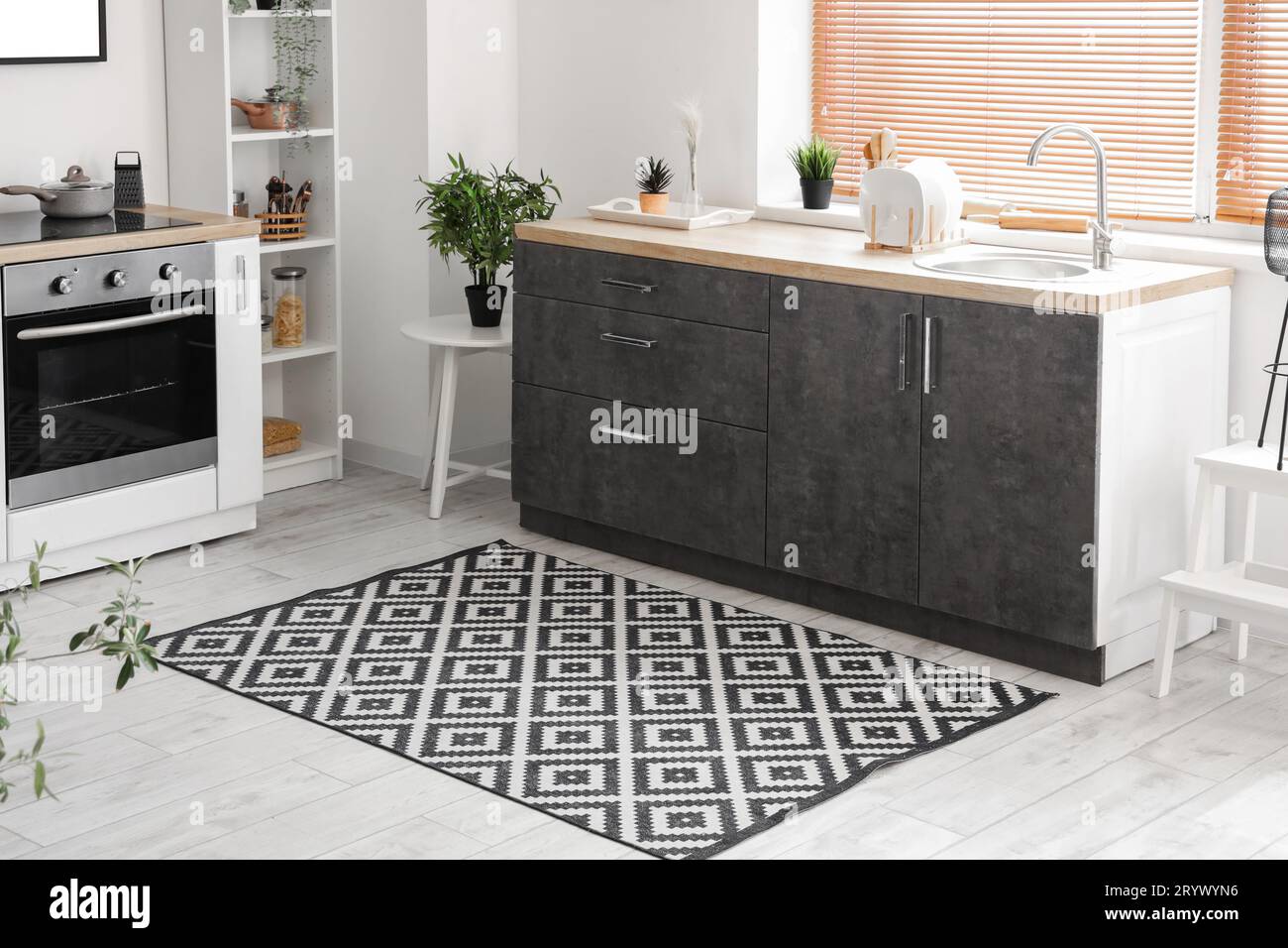 Interior of light kitchen with counters and carpet Stock Photo - Alamy