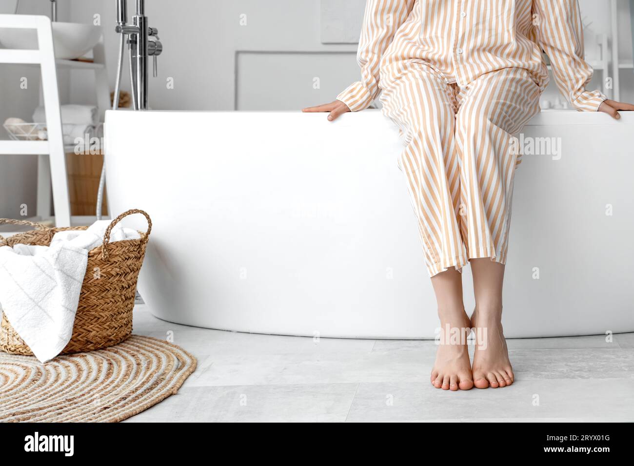 Barefoot woman in bathroom with floor heating Stock Photo - Alamy