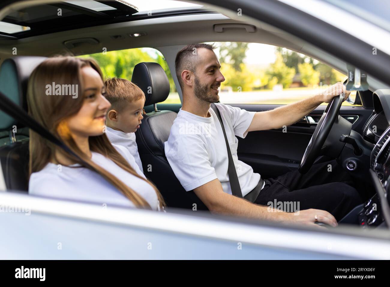 Cheerful young traditional family has a long auto journey and singing ...