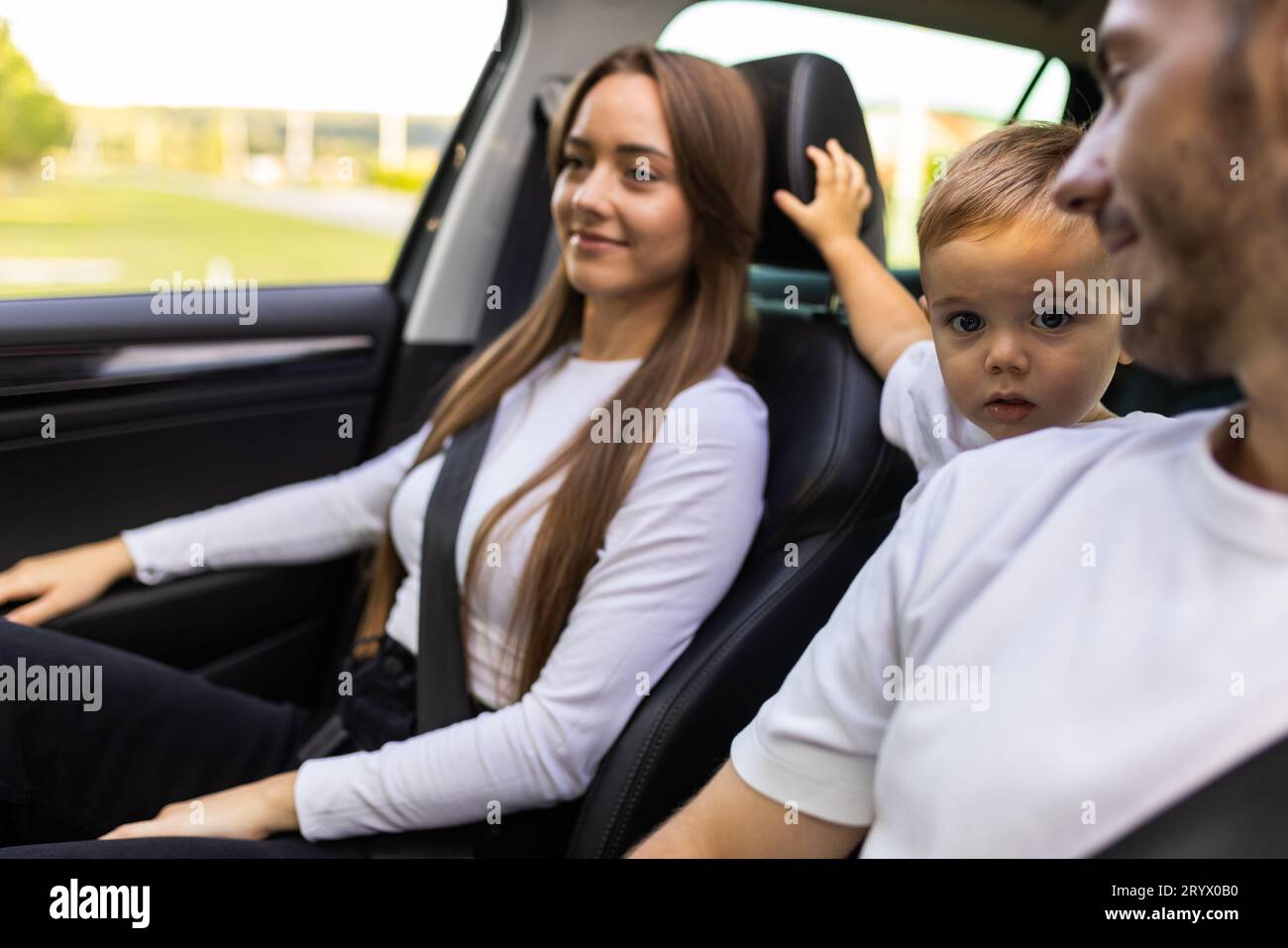 Cheerful young traditional family has a long auto journey and singing ...