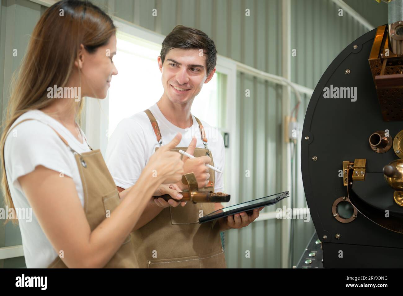 Working professional coffee roasting machine hi-res stock photography ...