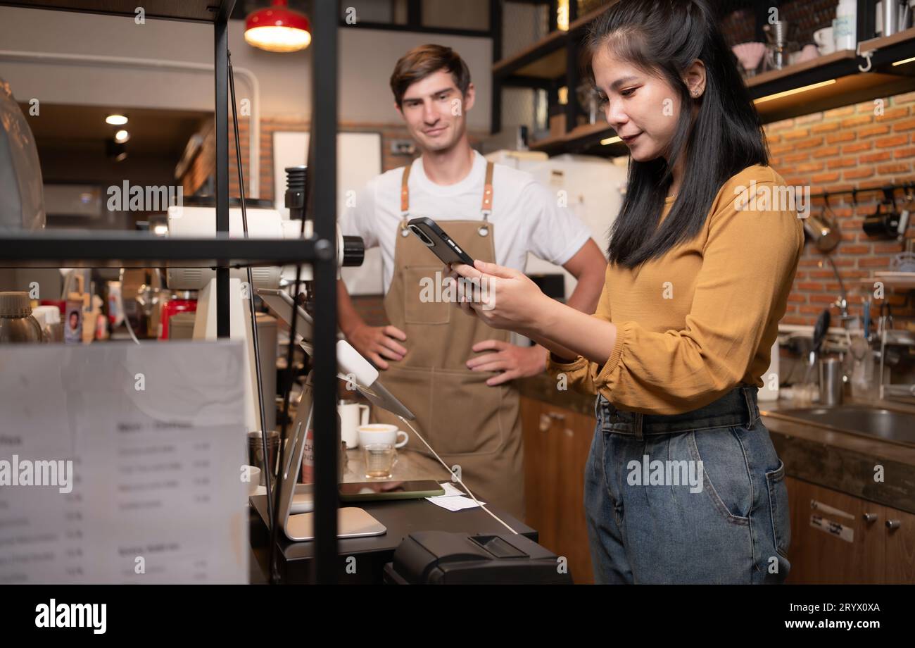Customers use their mobile phones to order coffee and pay for ...