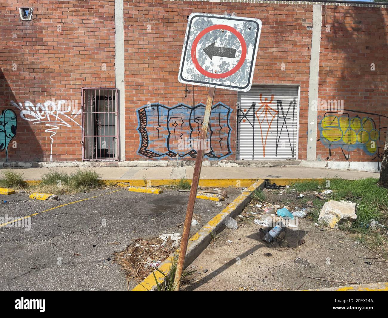 Sign with Old Left Turn Only Sign and Graffiti on Brick Wall and ...