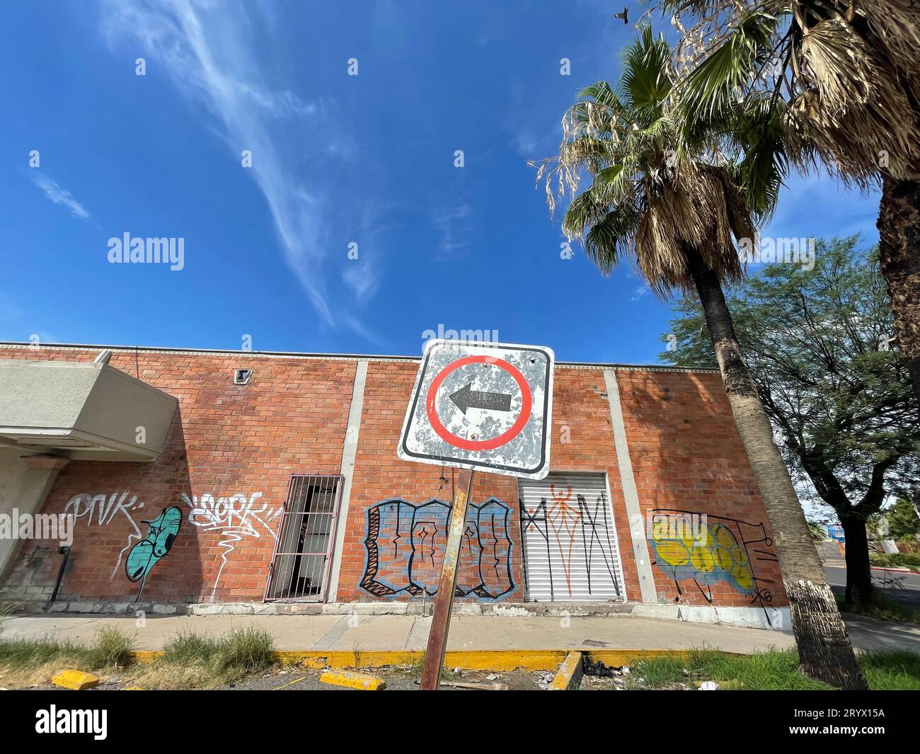 Sign with Old Left Turn Only Sign and Graffiti on Brick Wall and ...