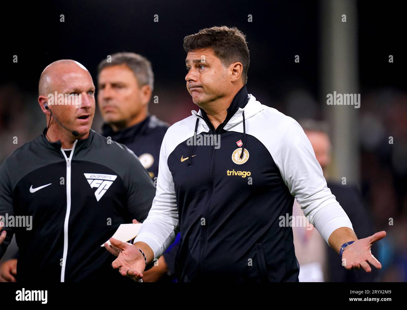 Chelsea manager Mauricio Pochettino (right) speaks to fourth official ...
