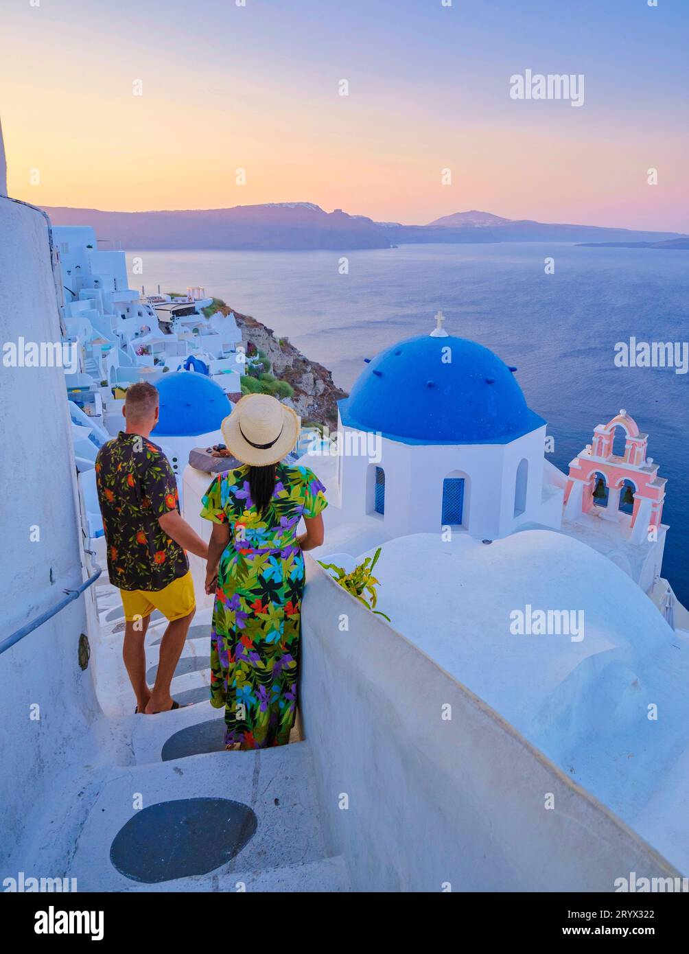 Couple walking at the Greek village of Oia Santorini Greece, men and ...
