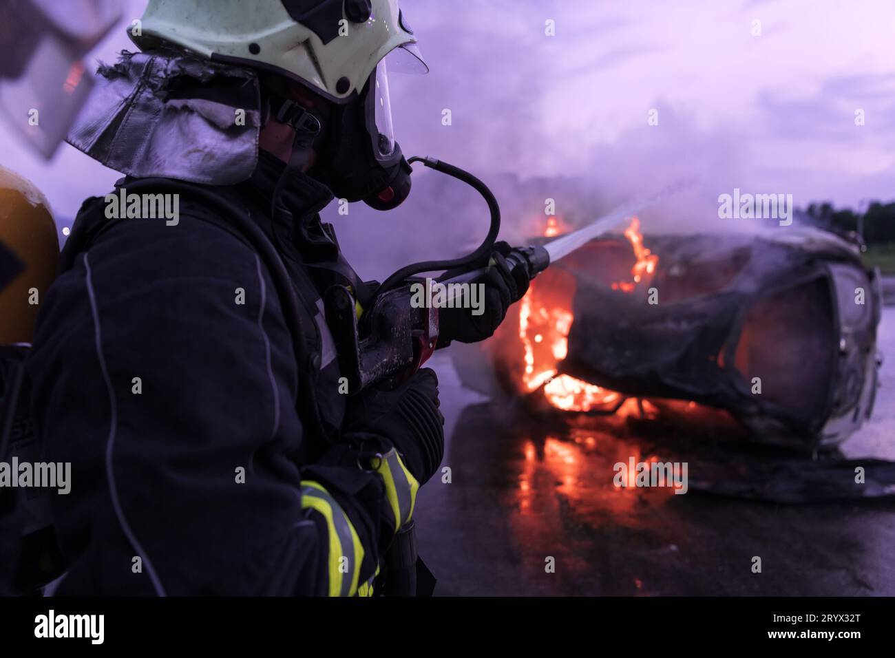Firefighters fight the fire flame to control fire not to spreading out ...