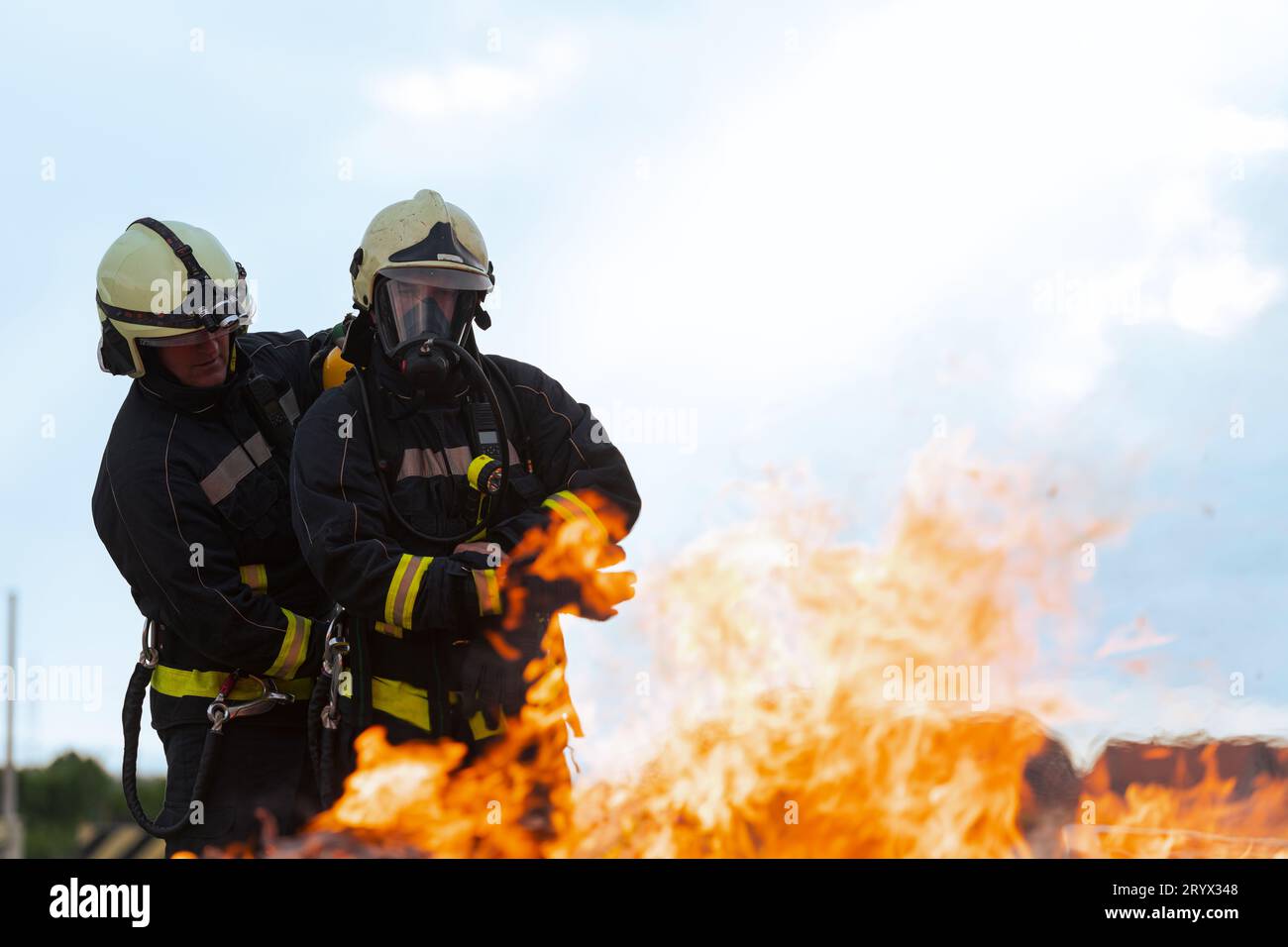 Firefighters fight the fire flame to control fire not to spreading out ...