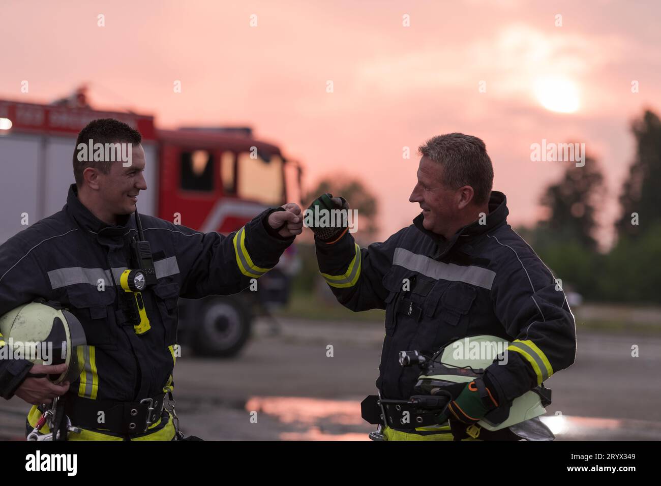 Fireman using walkie talkie at car traffic rescue action fire truck and ...
