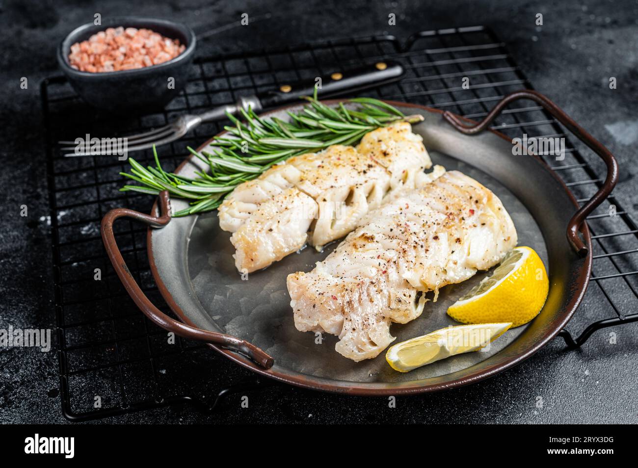 Roast Fillets of codfish, cooked cod fish meat. Black background. Top ...