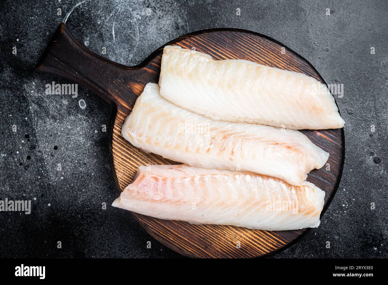 Fillets of codfish, raw cod fish meat. Black background. Top view Stock ...