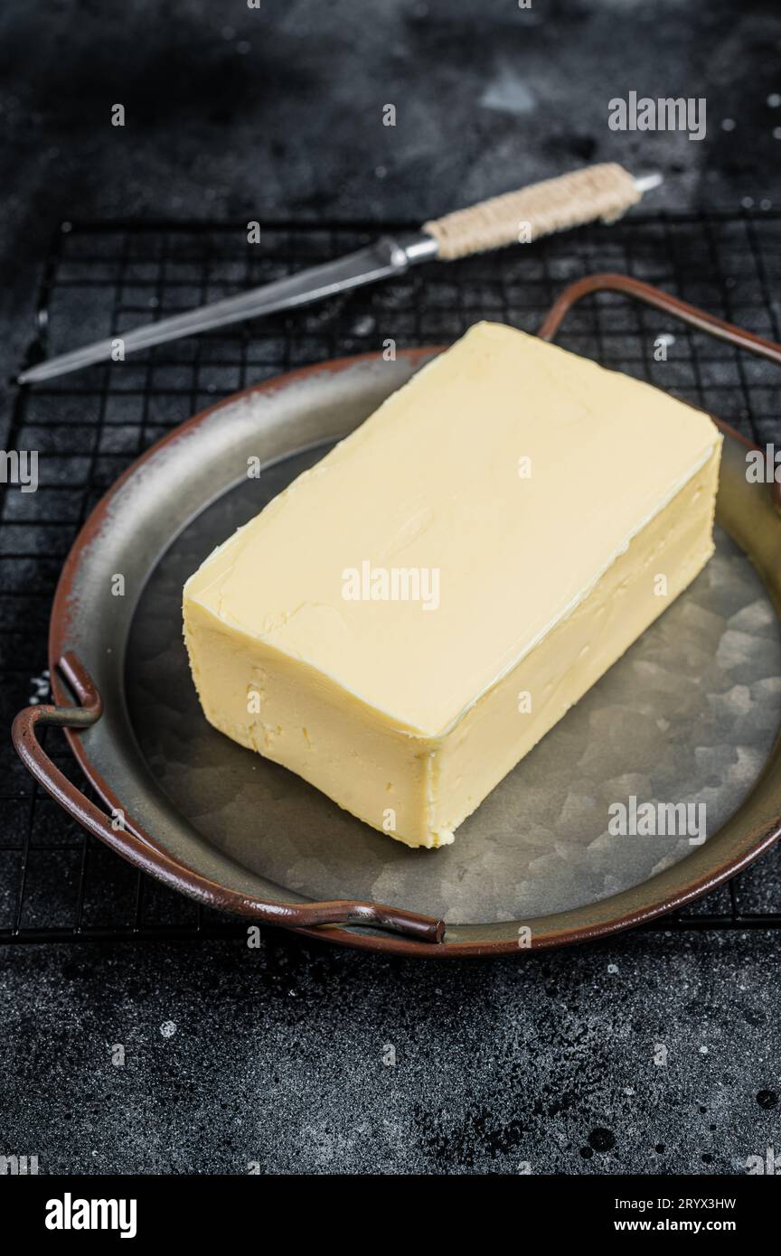 Butter block in steel kitchen tray. Black background. Top view Stock ...