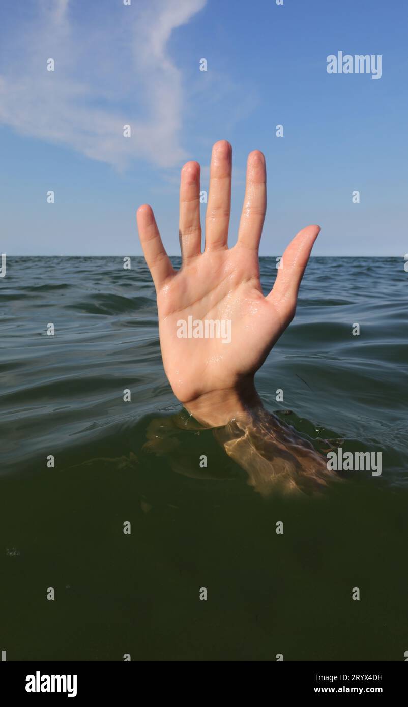five fingers of the hand while drowning in the ocean and asking for ...