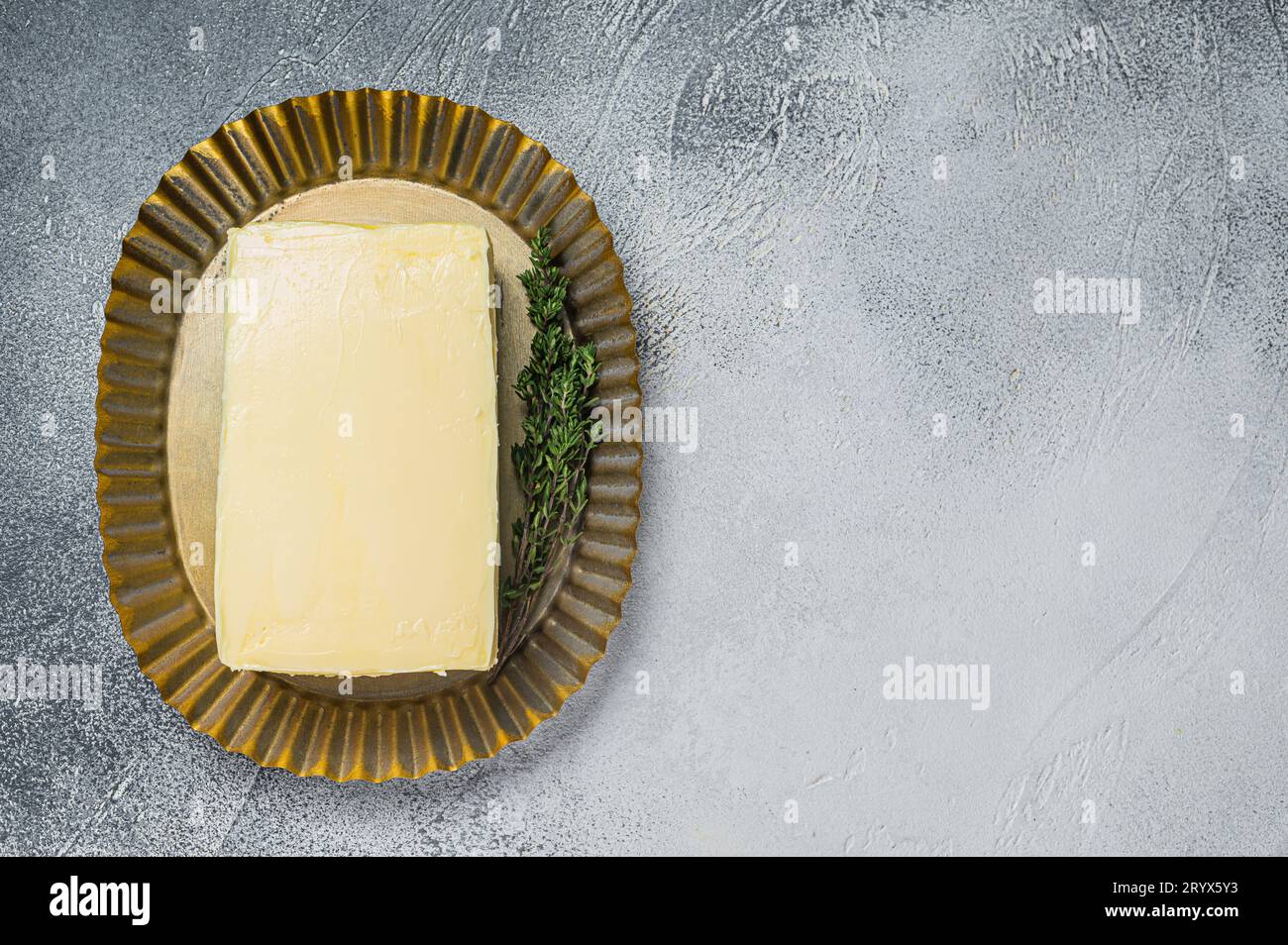 Butter block on steel plate. White background. Top view. Copy space ...