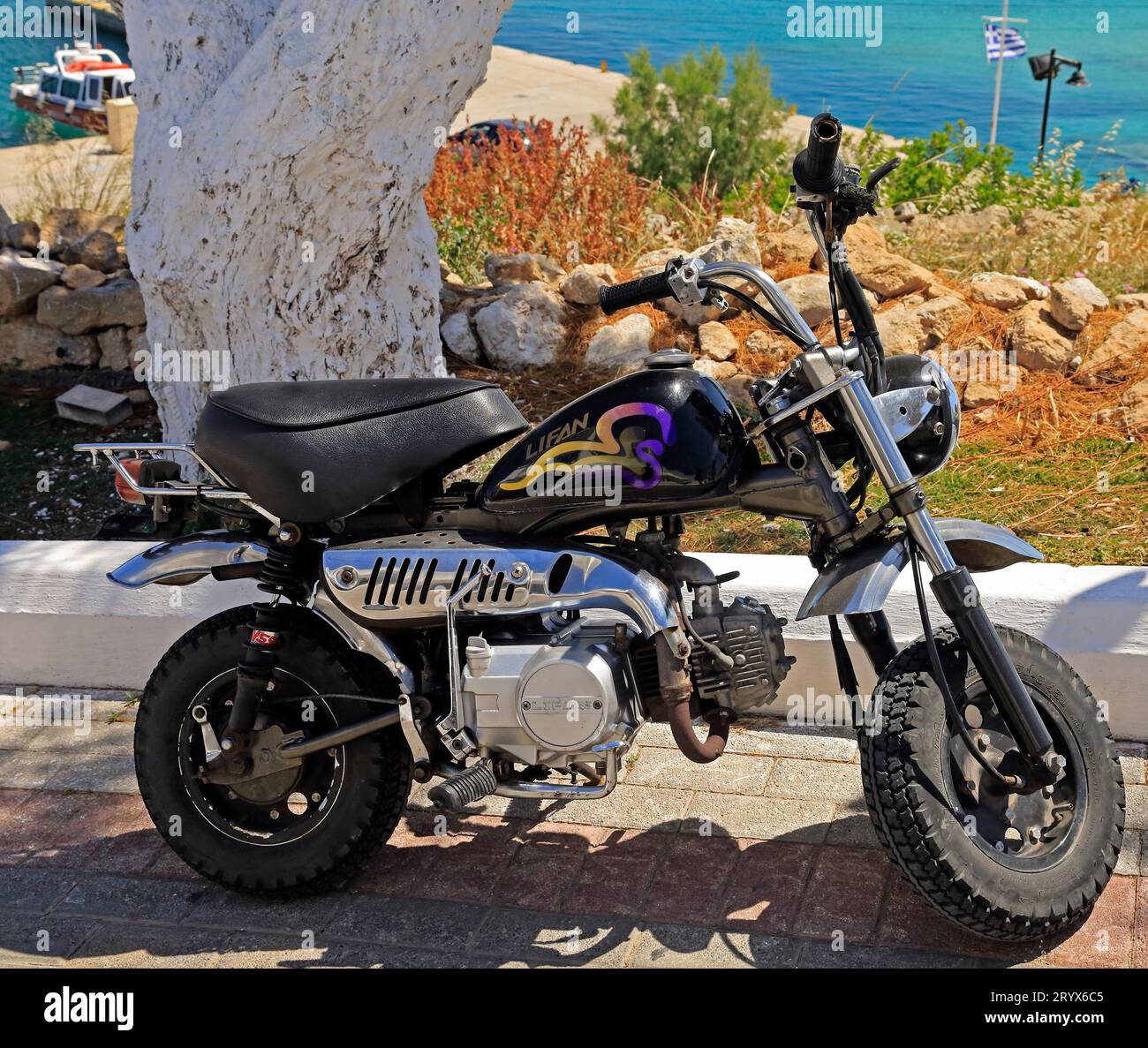 Mini motor bikes, parked by the roadside,Agistri island, Saronic island ...