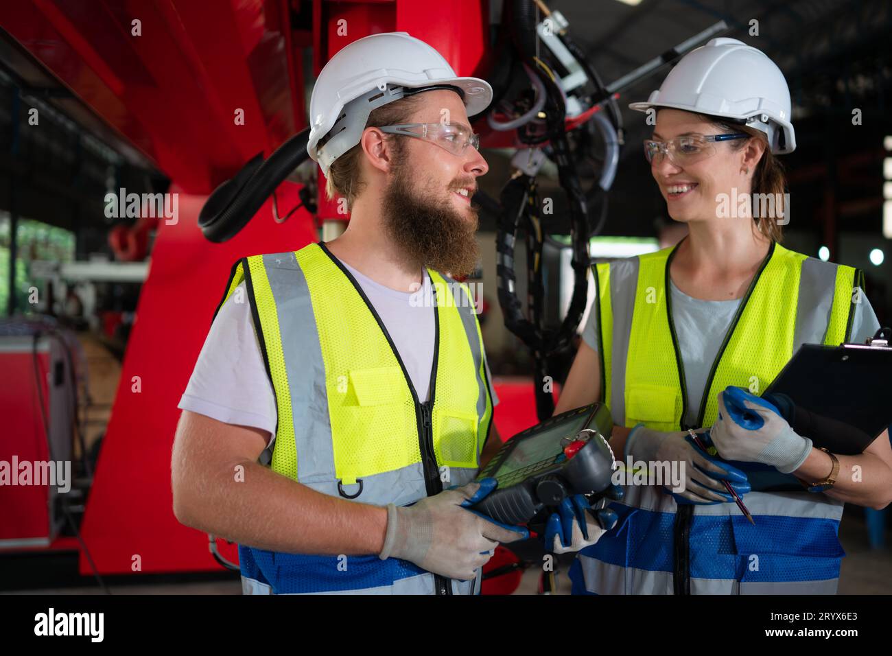 Both of engineers installing and testing a large robotic arm. before ...