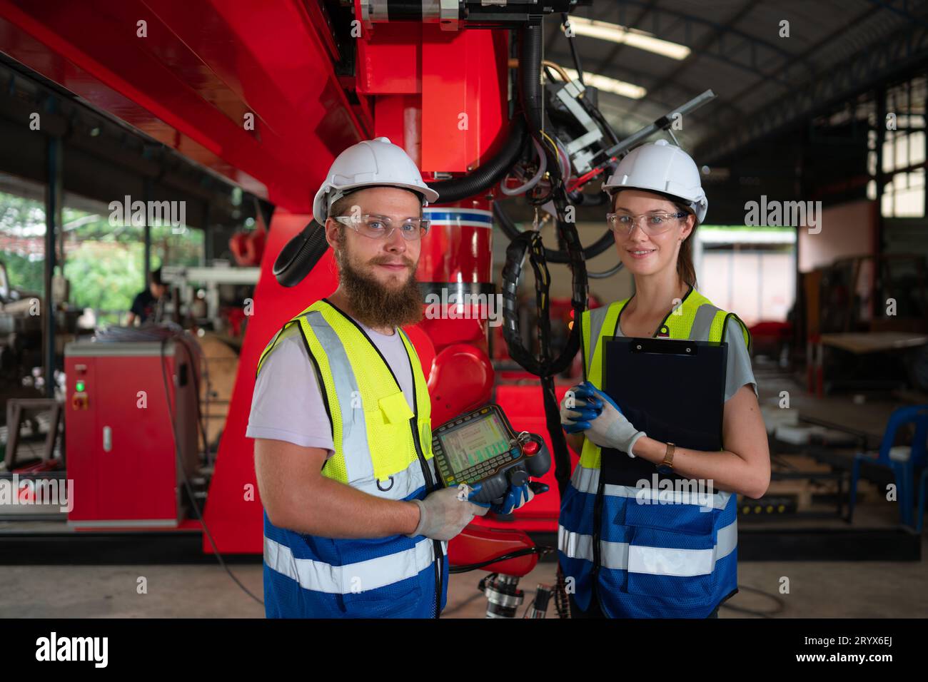 Both of engineers installing and testing a large robotic arm. before ...
