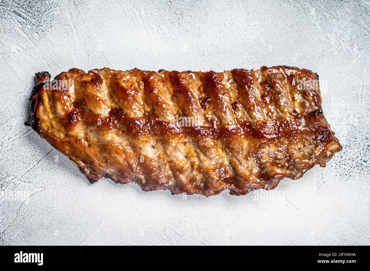 Barbecue grilled pork spare ribs. White background. Top view. Copy ...