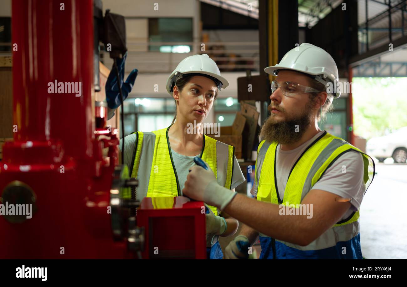 Both of mechanical engineers are checking the working condition of the ...