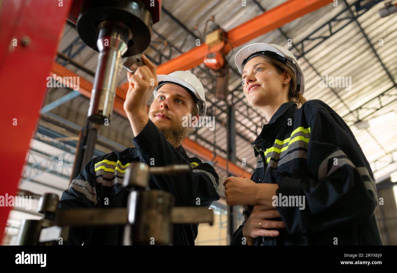 Both of mechanical engineers are checking the working condition of the ...