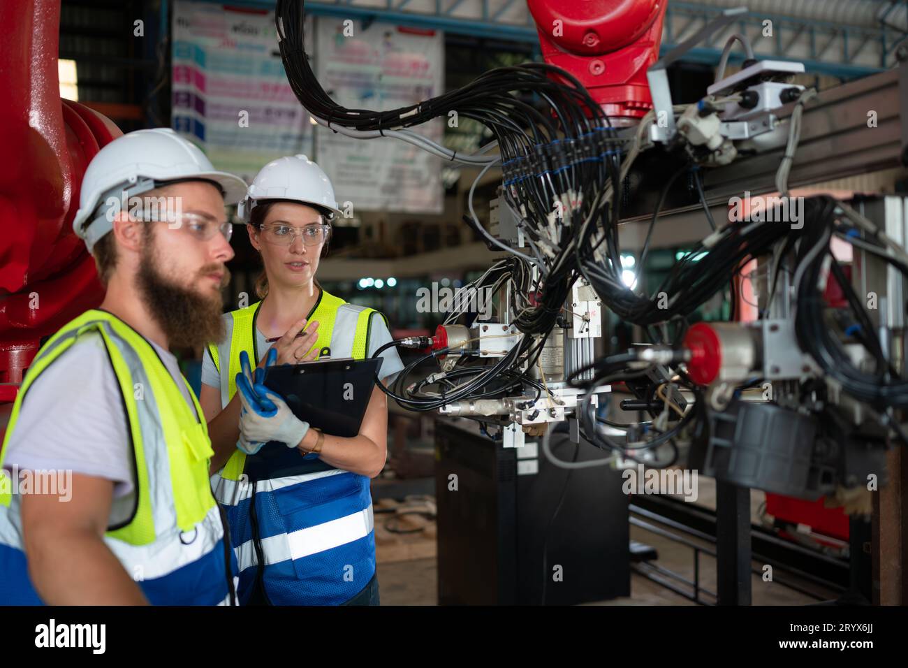 Both of engineers installing and testing a large robotic arm. before ...