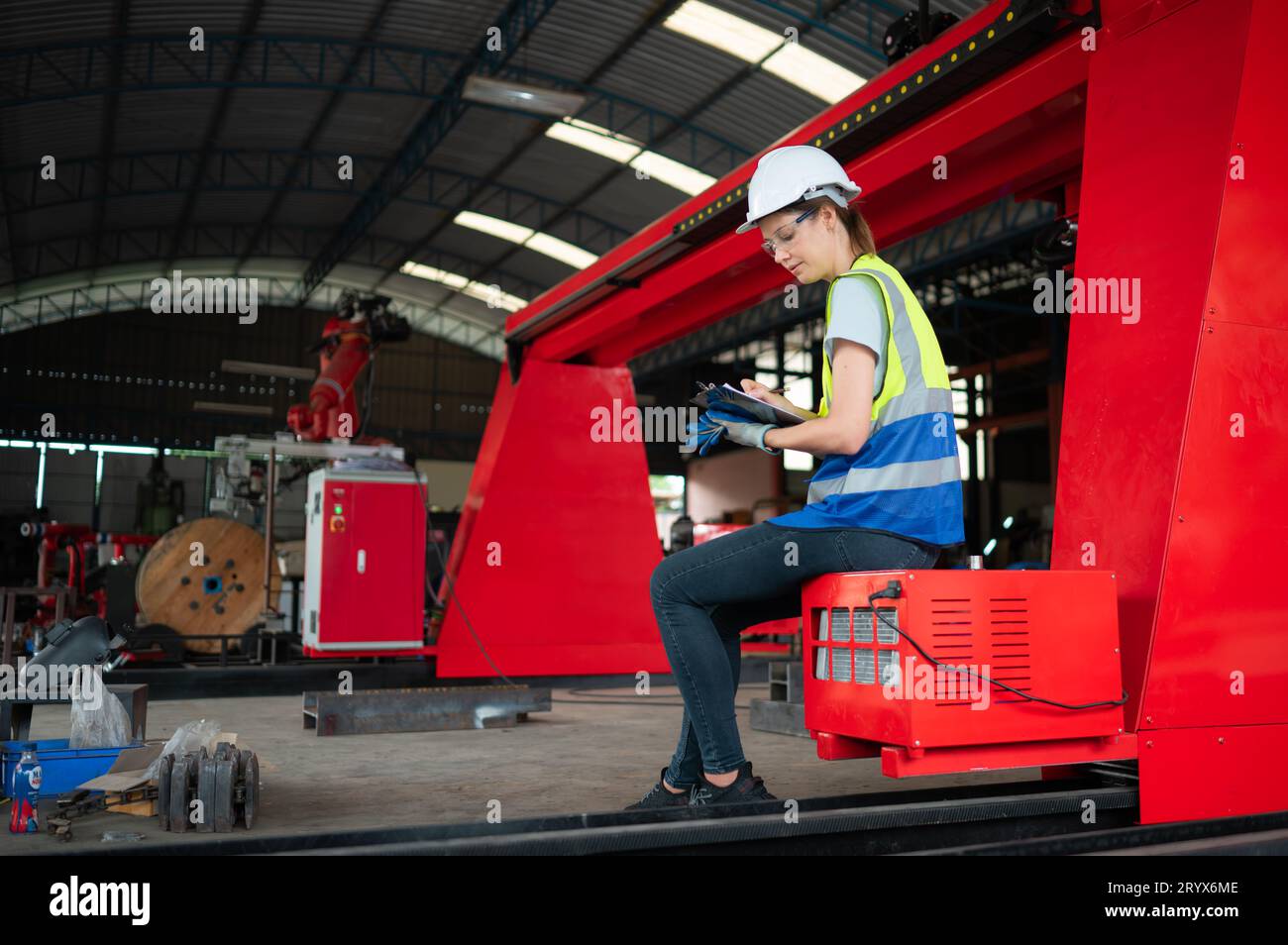 An engineers installing and testing a large robotic arm. before sending ...