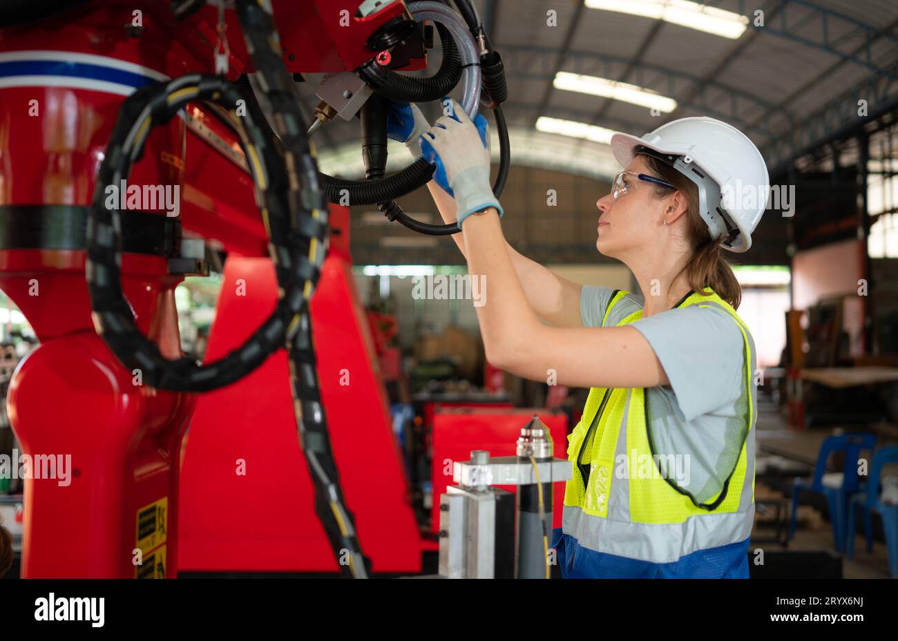An engineers installing and testing a large robotic arm. before sending ...
