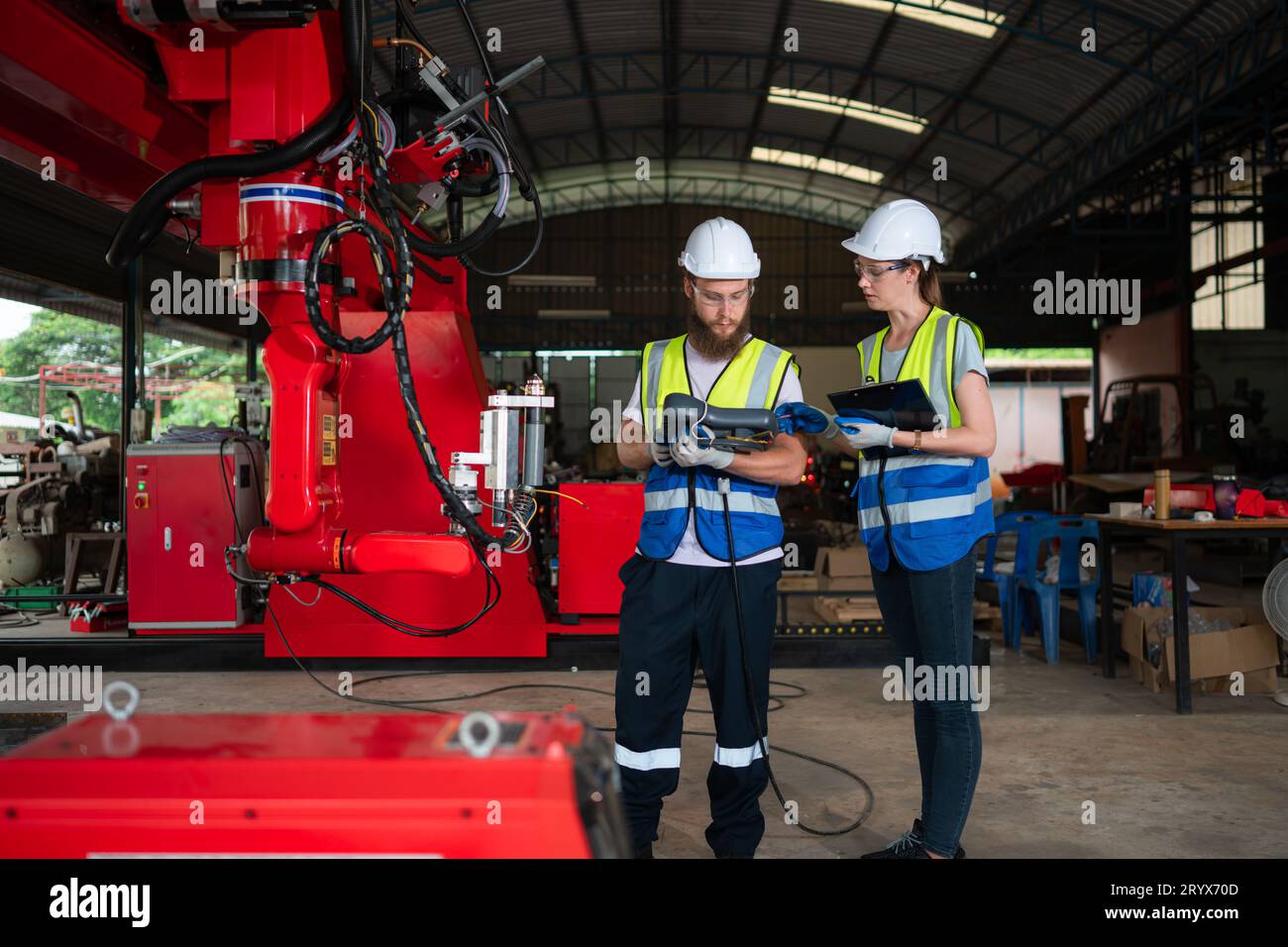 Both of engineers installing and testing a large robotic arm. before ...